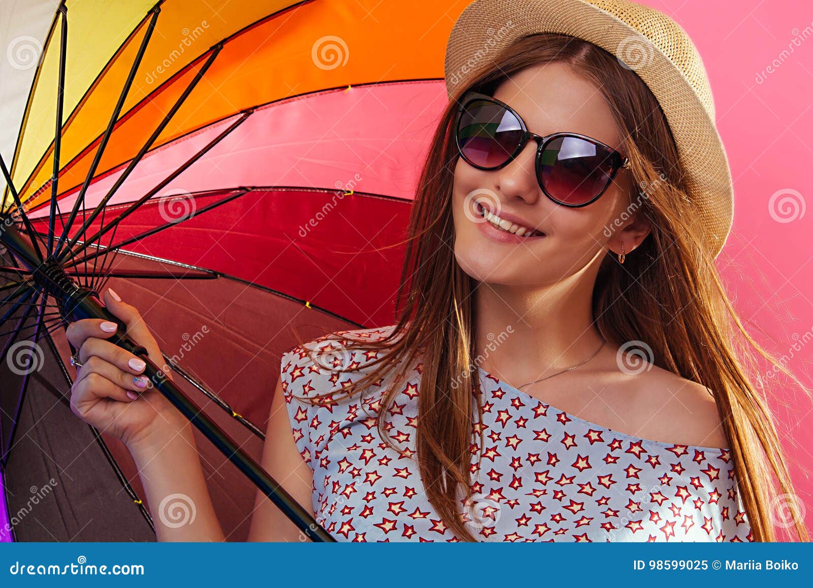 Portrait Of A Pretty Woman With Colorful Umbrella Wearing Sunglasses