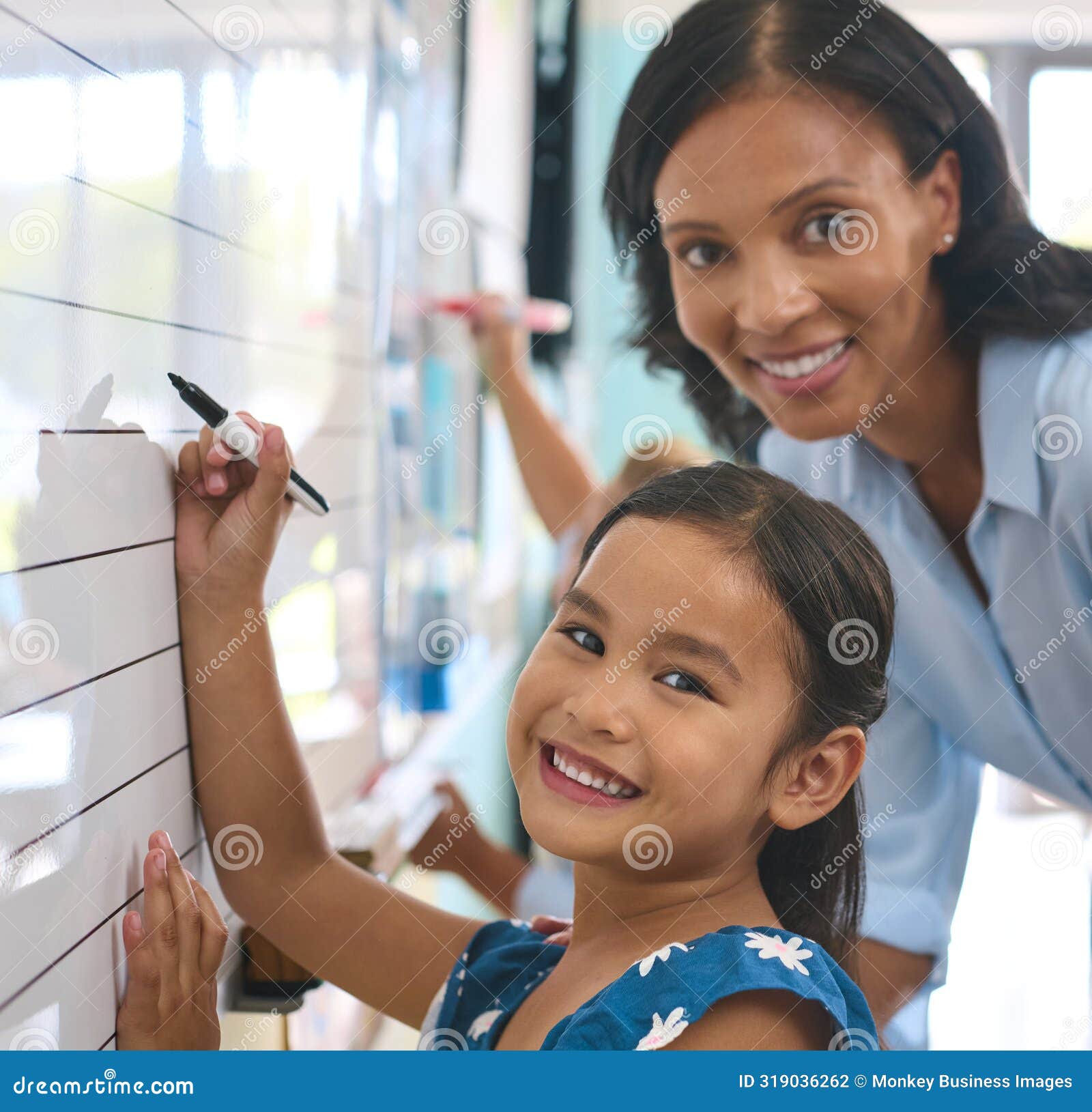Portrait of Primary or Elementary School Student with Teacher Writing ...