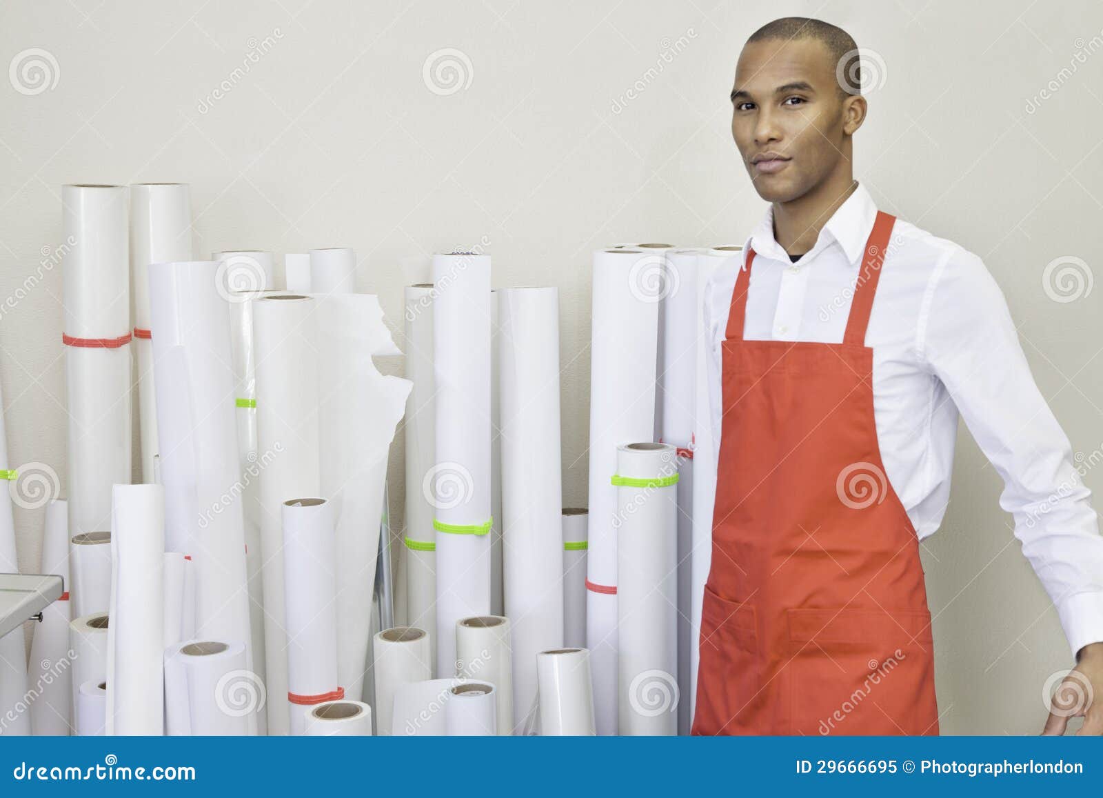 Portrait of Printing Press Worker Standing with Paper Rolls in ...