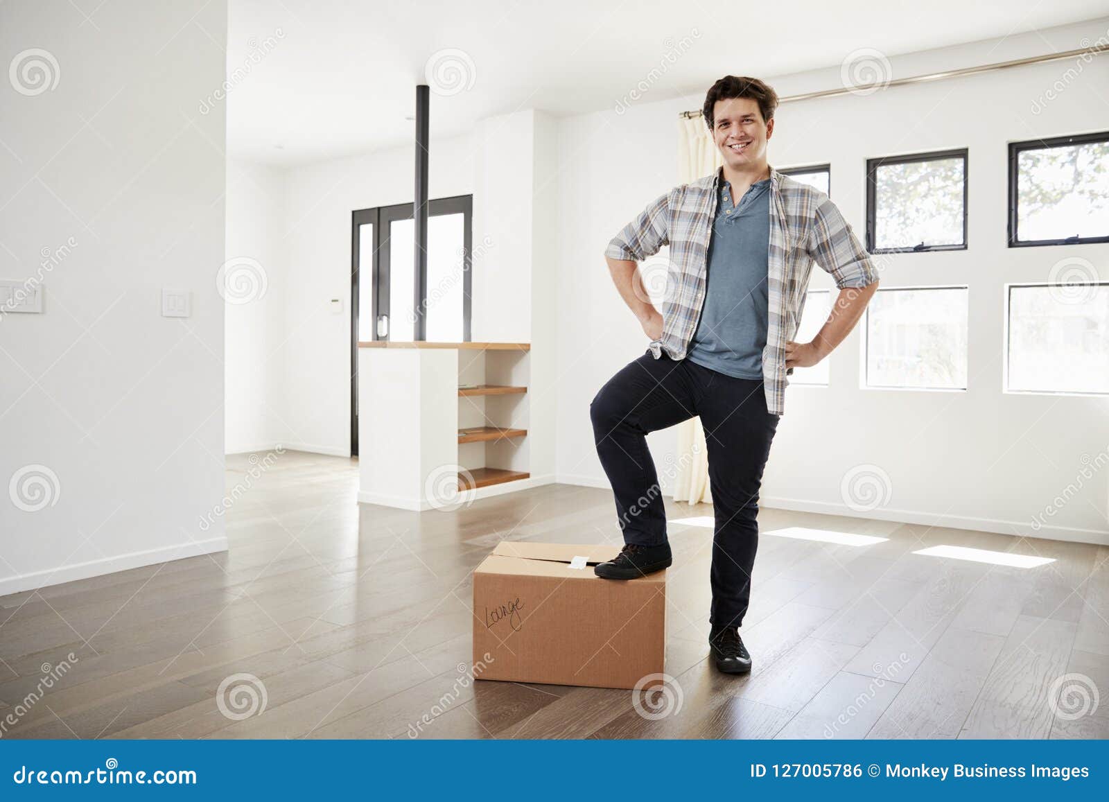 Portrait of Proud Man Standing on Box in New Home on Moving Day Stock ... Portrait of Proud Man Standing on Box in New Home on Moving Day Stock ...