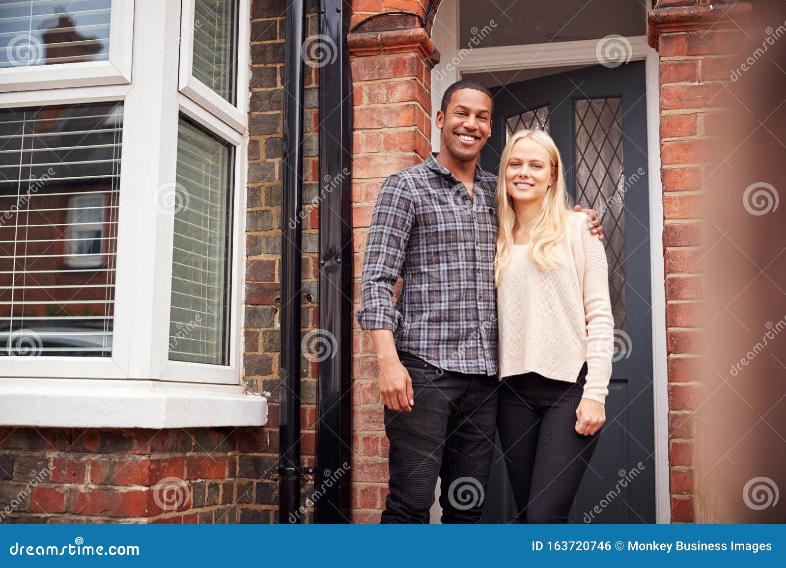 Portrait of Proud Young Couple Standing Outside First Home Together ... Portrait of Proud Young Couple Standing Outside First Home Together ...