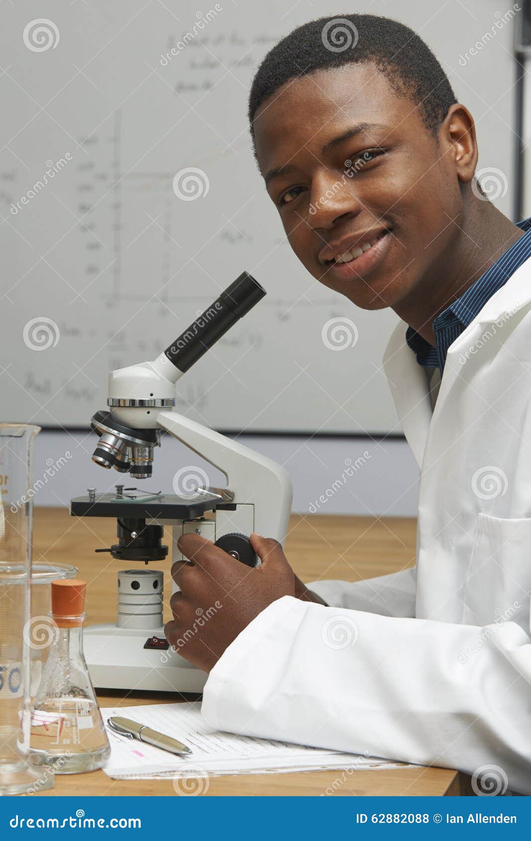 Portrait of Pupil Using Microscope in Science Lesson Stock Photo ...