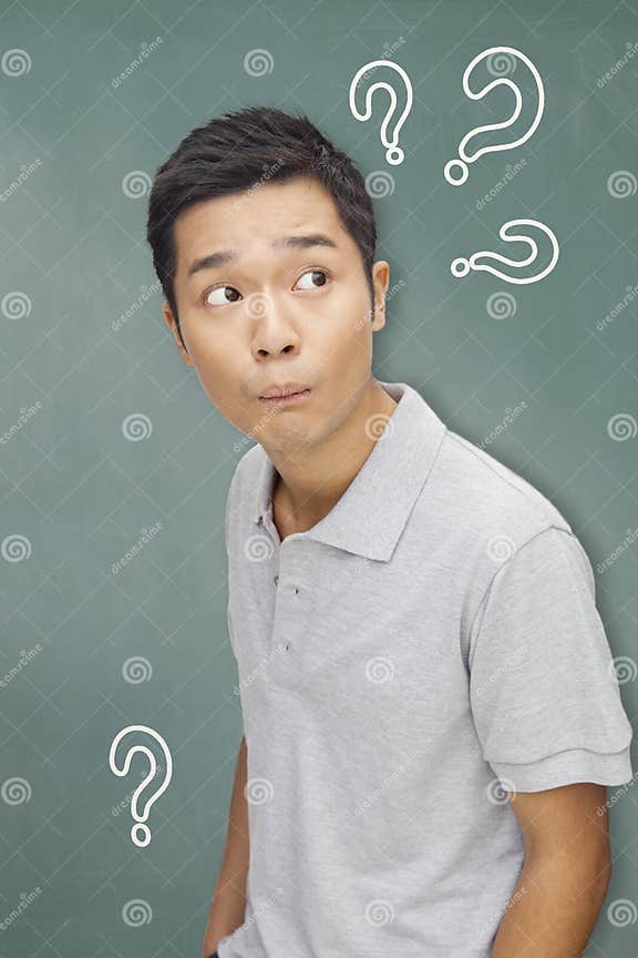 Portrait Questioning Young Man in Front of Blackboard with Question ... Portrait Questioning Young Man in Front of Blackboard with Question ...