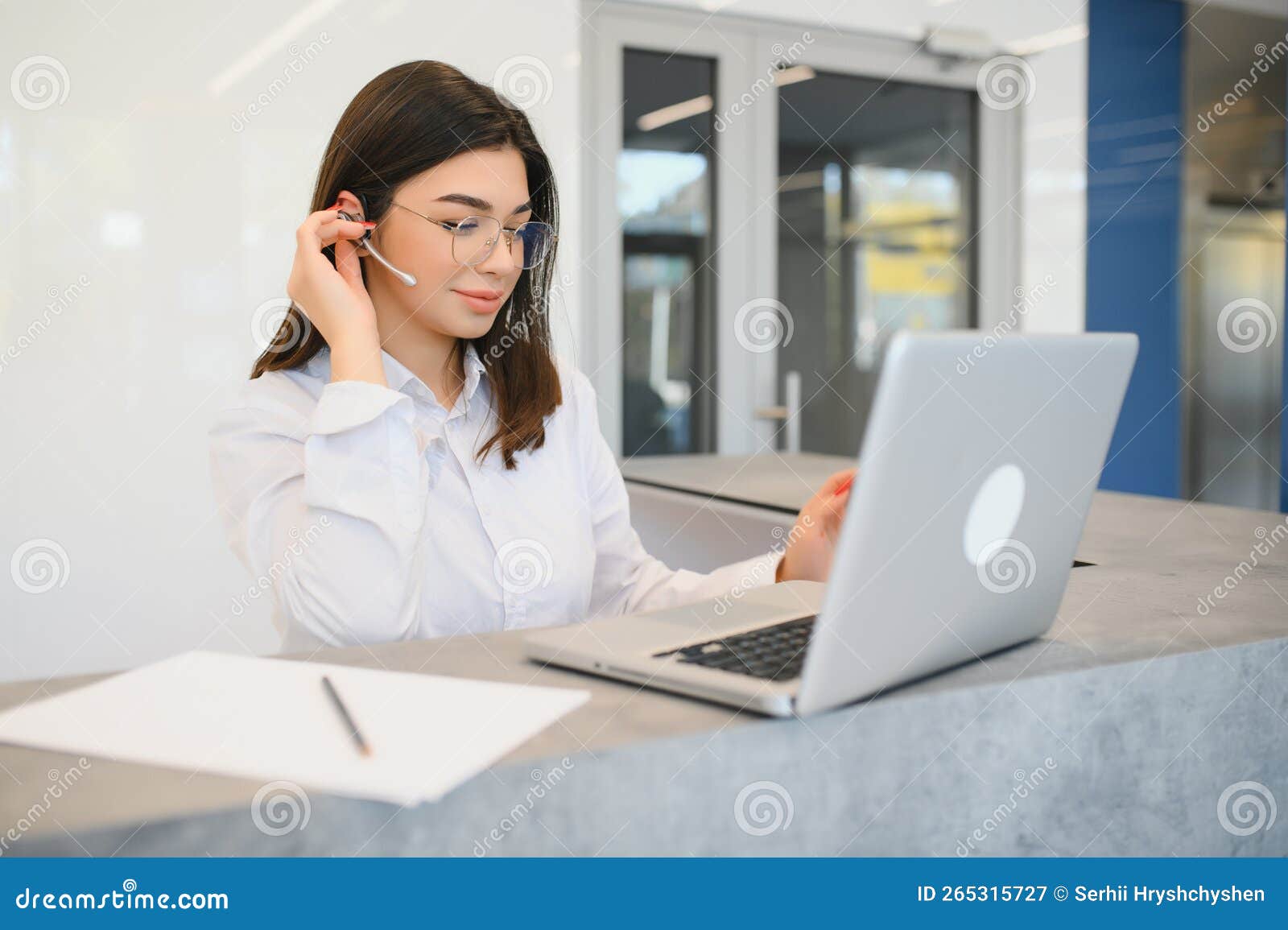 Portrait of Receptionist at Desk in Lobby Stock Image - Image of desk ...