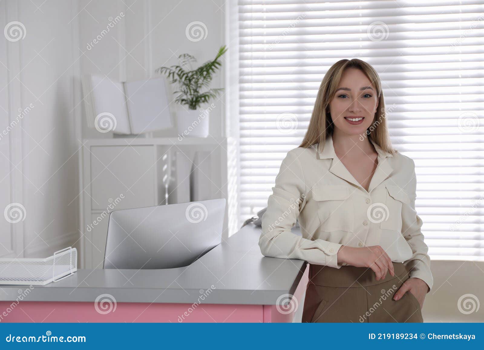 Portrait of Receptionist Near Countertop in Office, Space for Text ...