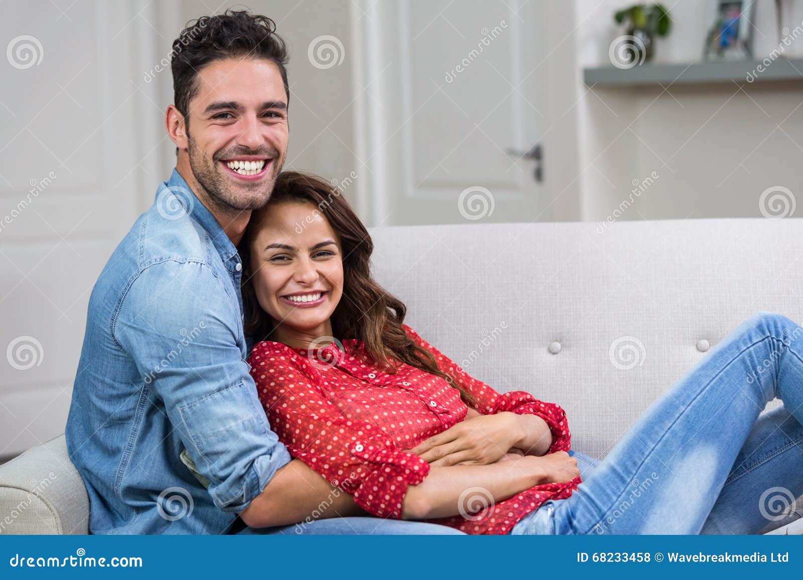 Portrait of Romantic Couple Hugging on Sofa Stock Photo - Image of ...