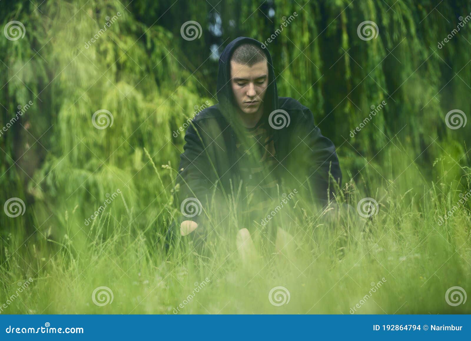 Portrait of a Sad, Crouching Man Stock Photo - Image of adult, hood ...