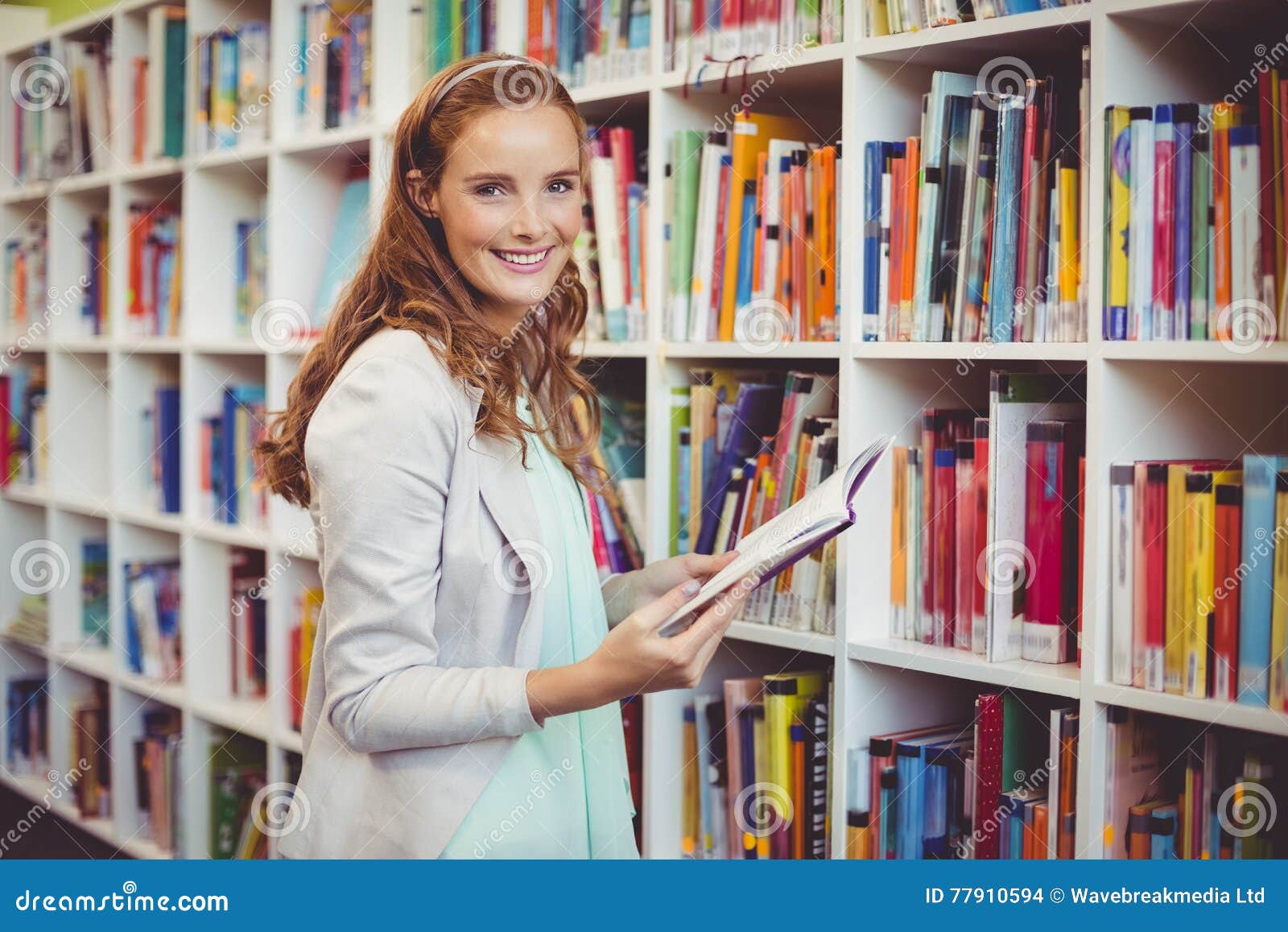 Portrait of School Teacher Holding Book in Library Stock Photo - Image ...