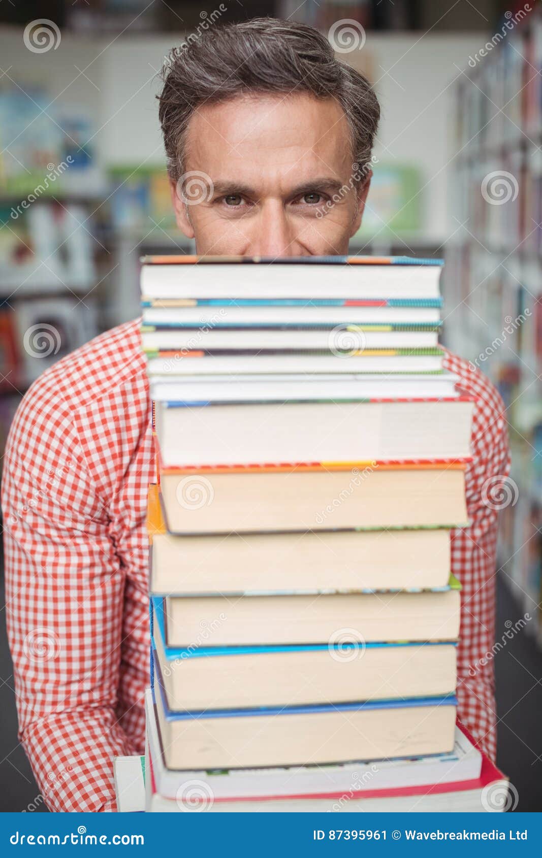 Portrait of School Teacher Holding Stack of Books in Library Stock ...
