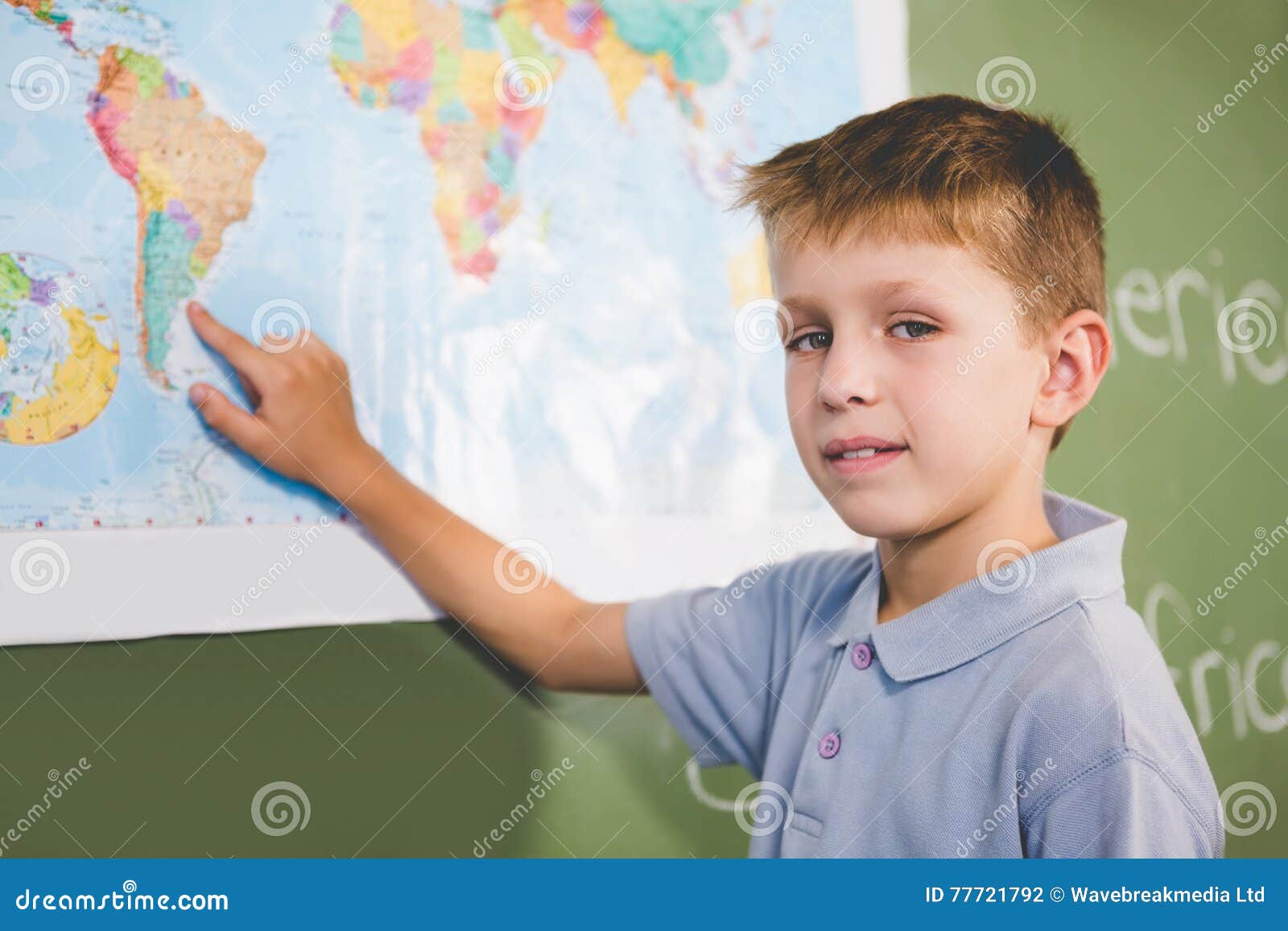 Portrait of Schoolboy Pointing at Map in Classroom Stock Photo - Image ...