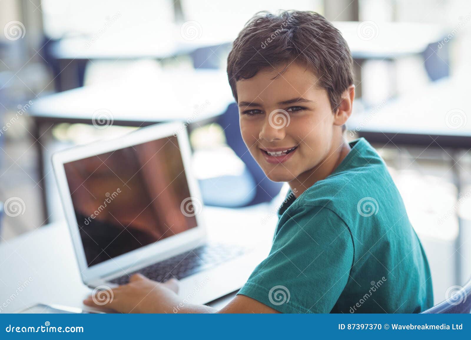 Portrait of Schoolboy Using Laptop in Classroom Stock Photo - Image of ...