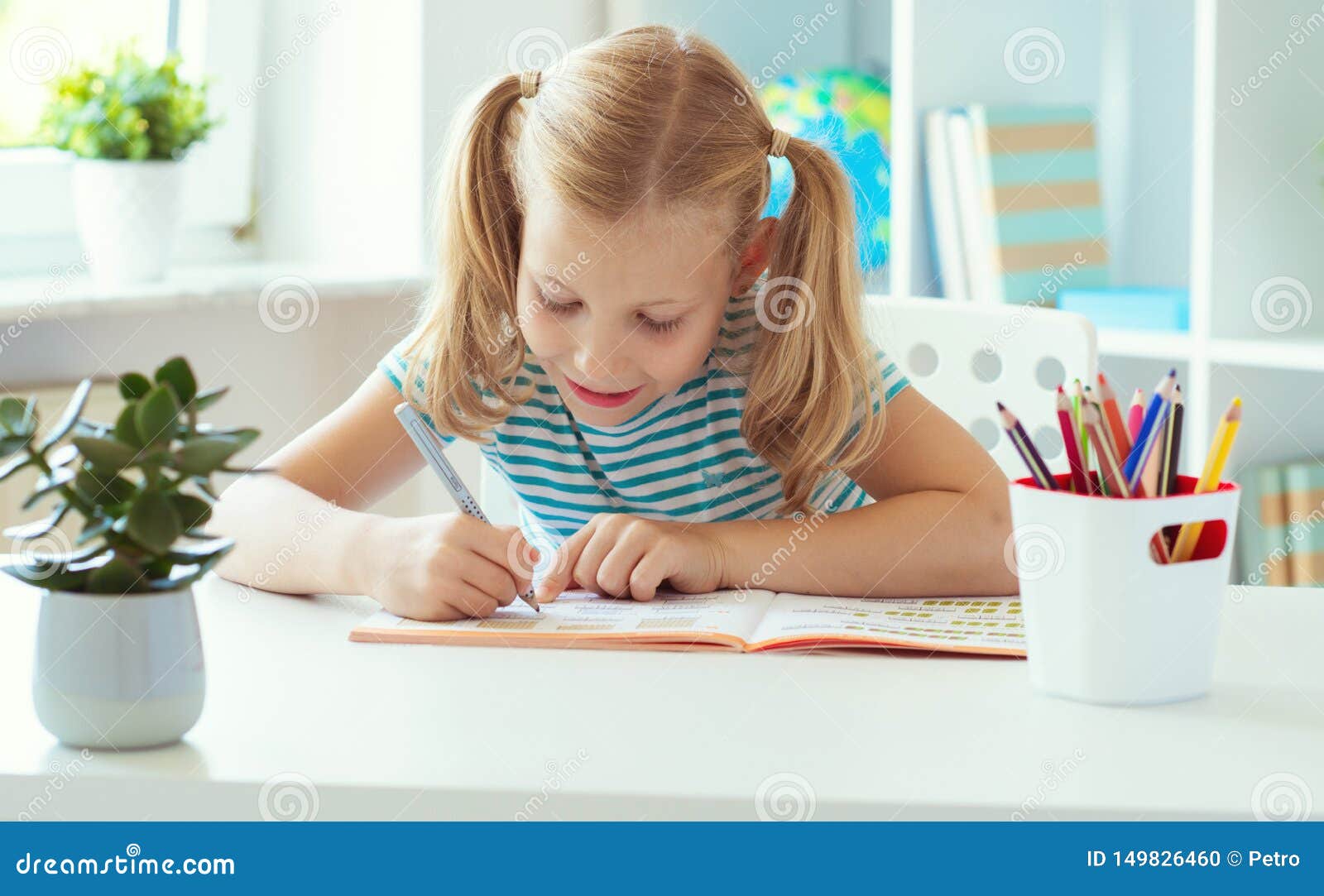Portrait of Schoolgirl at Classroom Writing at the Table Stock Photo ...