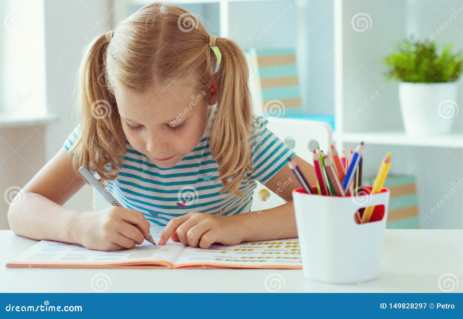 Portrait of Schoolgirl at Classroom Writing at the Table Stock Image ...