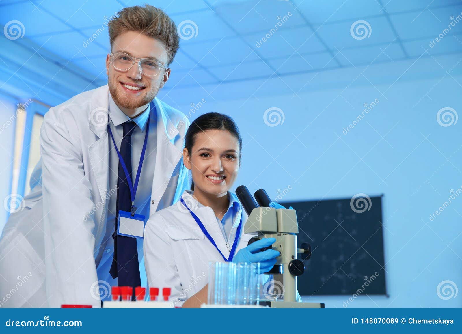 Portrait Of Scientists In Lab Coats And Goggles Standing In Modern ...