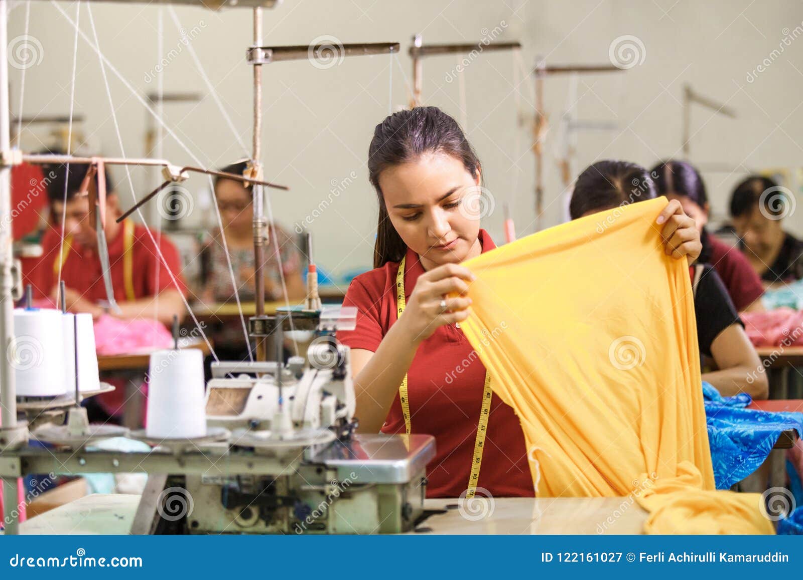 Seamstress In Textile Factory Sewing Using Industrial Sewing Mac Stock