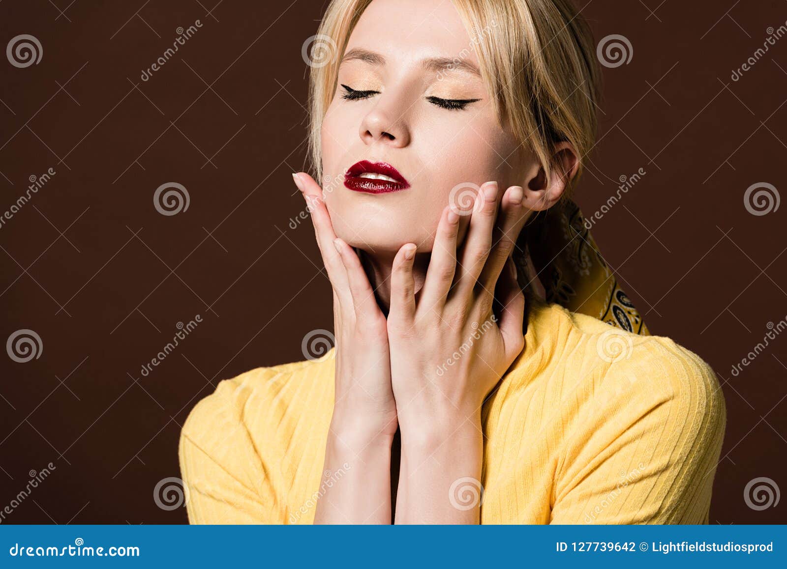 Portrait Of Seductive Young Blonde Woman Touching Face With Hands Stock