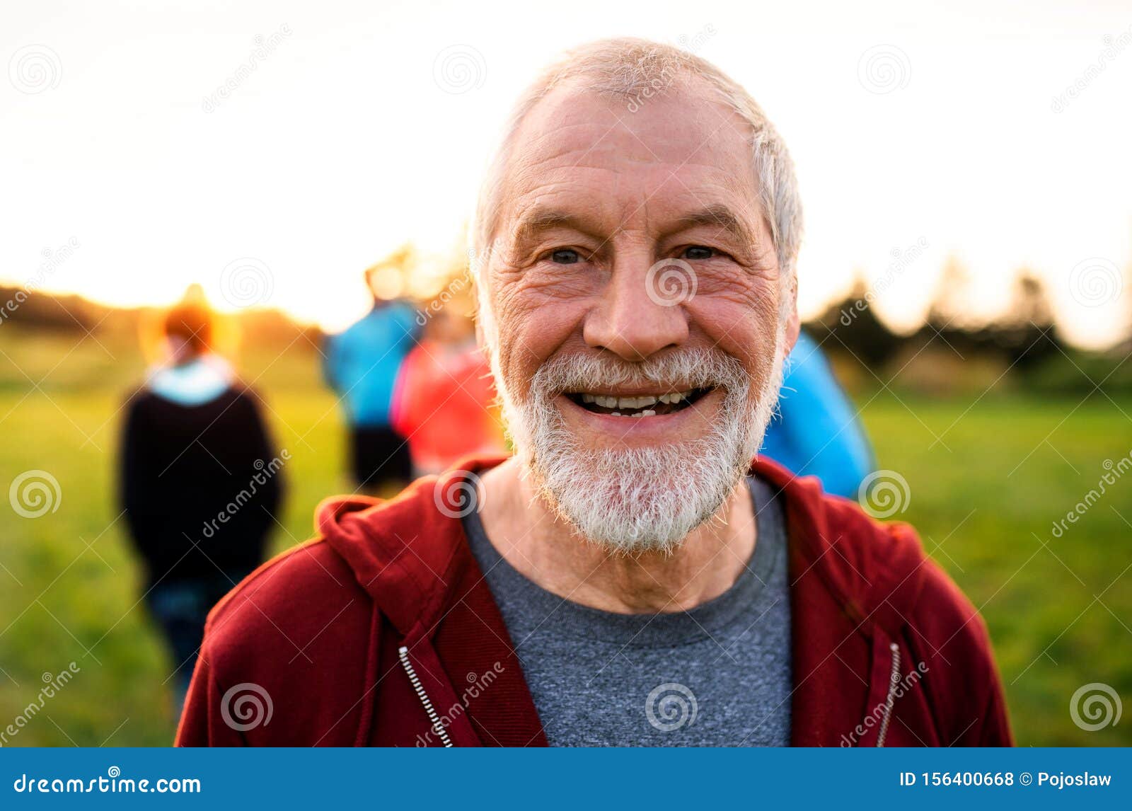 A Portrait of Senior Man with Large Group of People Doing Exercise in ...