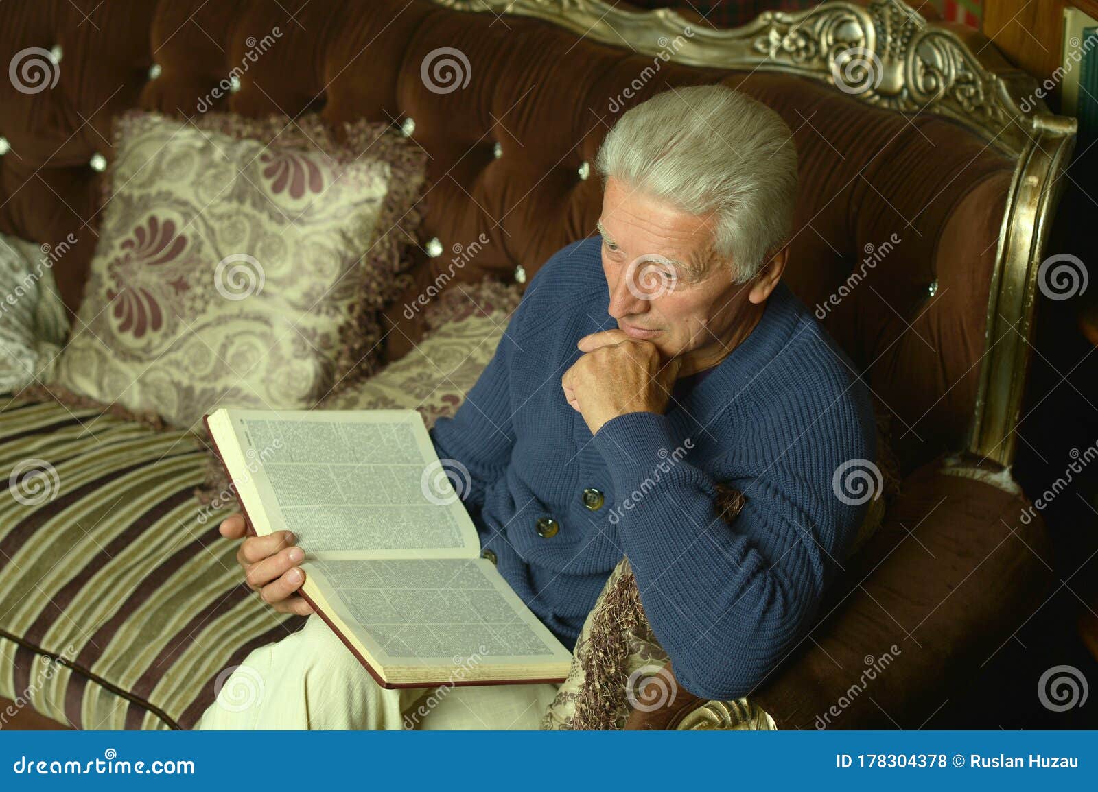 Portrait of Senior Man Reading Book while Sitting Stock Photo - Image ...