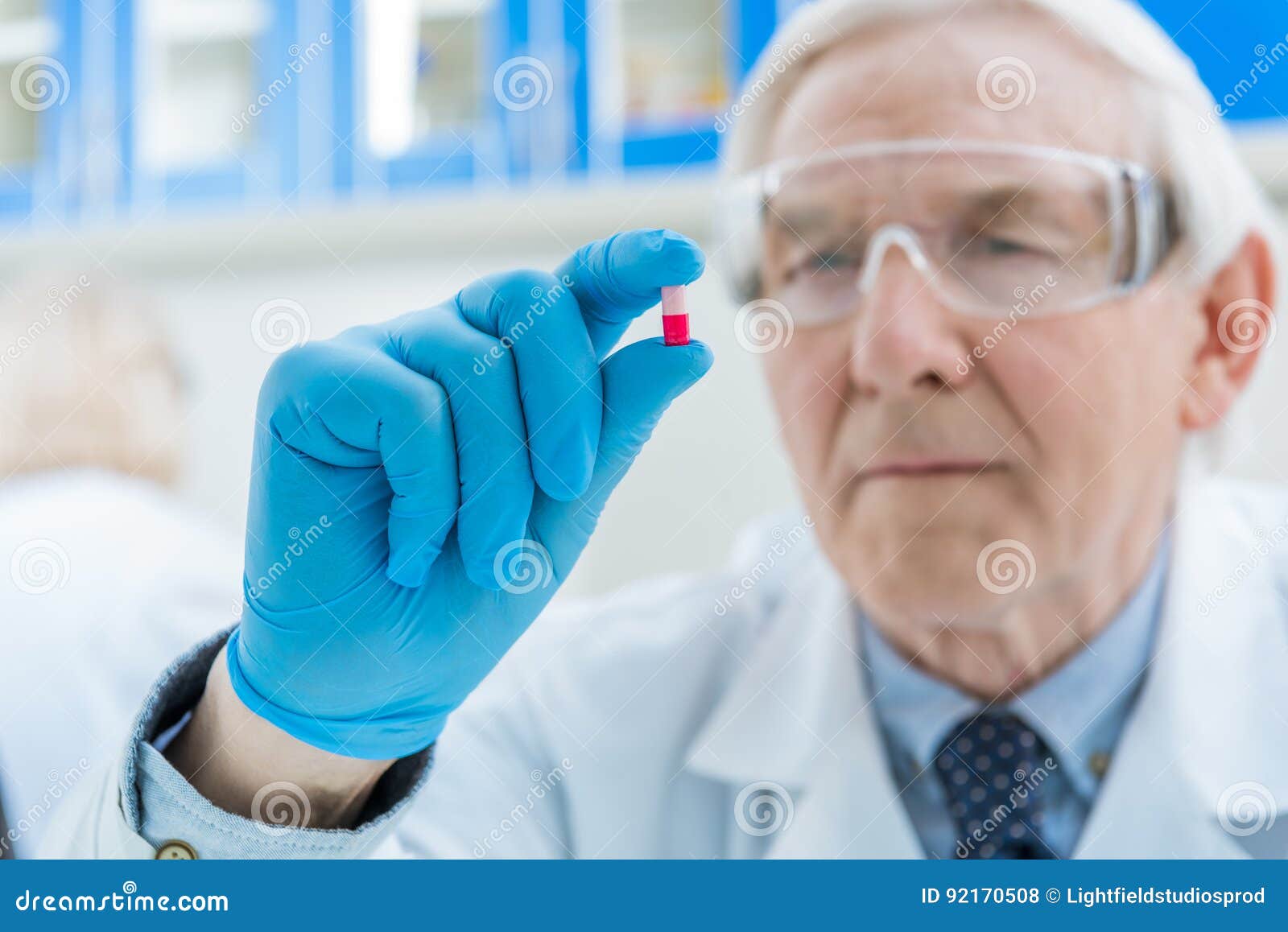 Portrait of Senior Man Scientist Analyzing Pill in Hand Stock Photo ...