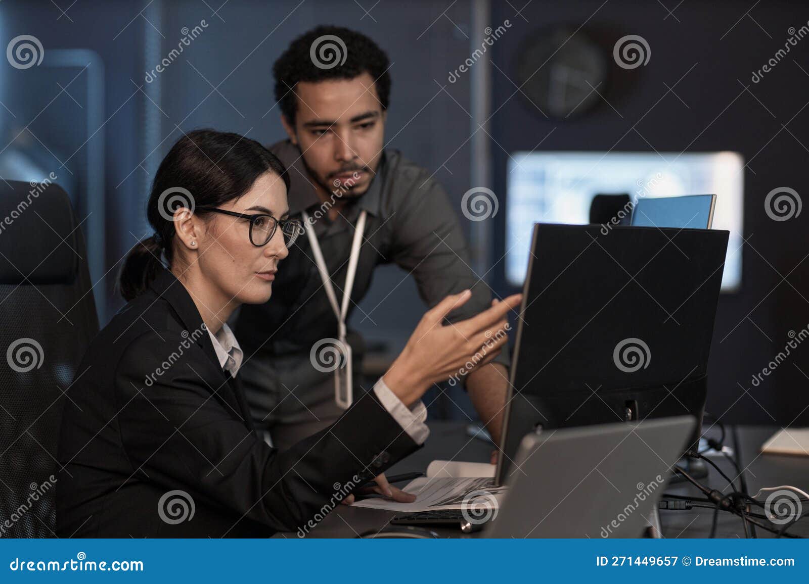 Senior Project Manager Pointing at Computer Screen while Reviewing Code ...