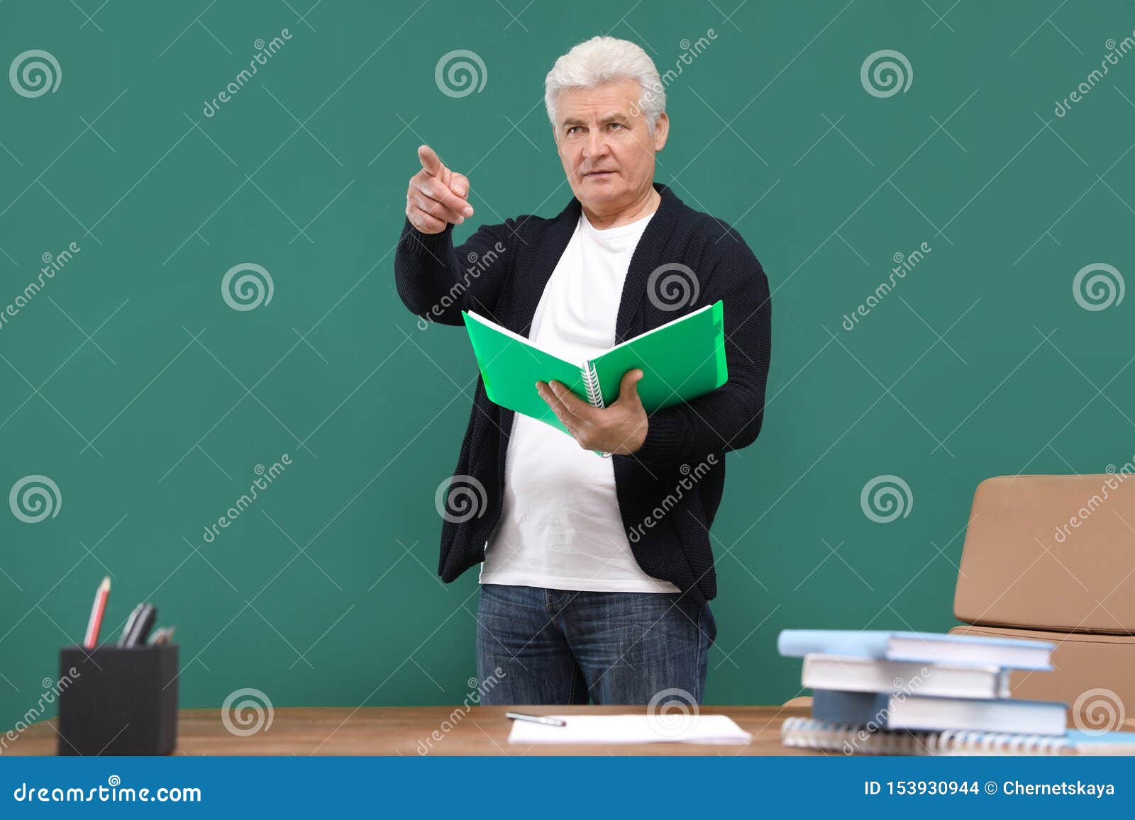 Portrait of Senior Teacher with Notebook at Green Chalkboard Stock ...