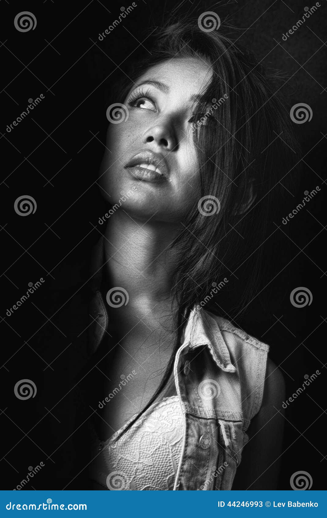 Portrait Of The Sensual Girl In Jeans Jacket On The Black Background