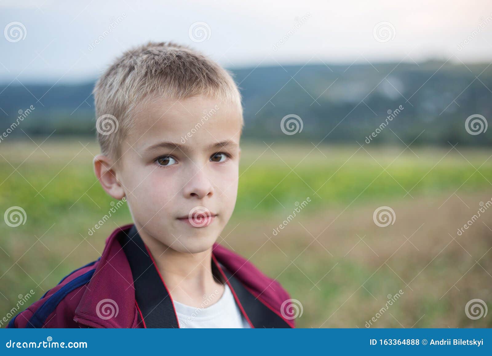 Portrait of a Serious Child Boy Outdoors Stock Photo - Image of meadow ...