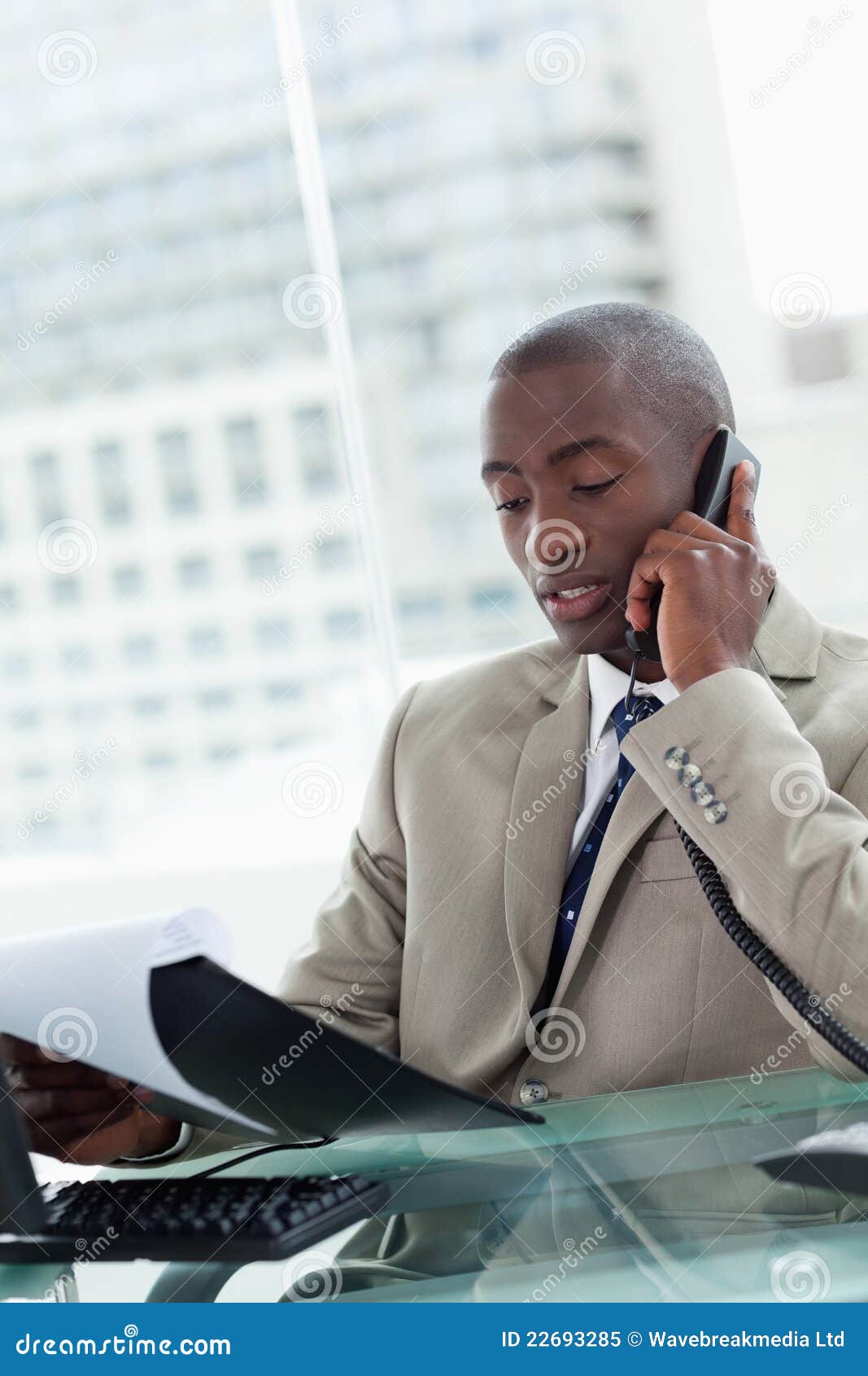Portrait of a Serious Entrepreneur Making a Phone Call while Reading a ...