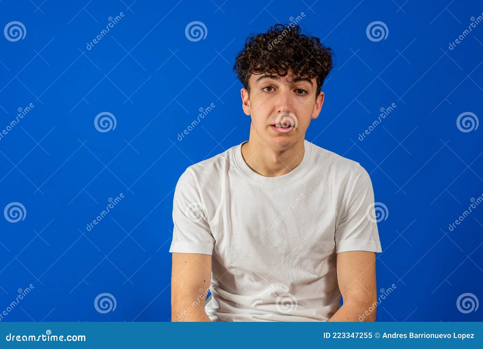 Portrait of a Serious Young Man Standing on Blue Background Stock Image ...
