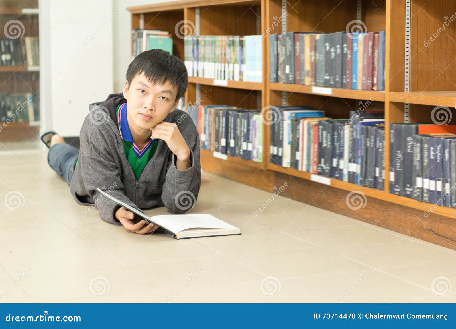Portrait of a Serious Young Student Reading a Book in a Library Stock ...