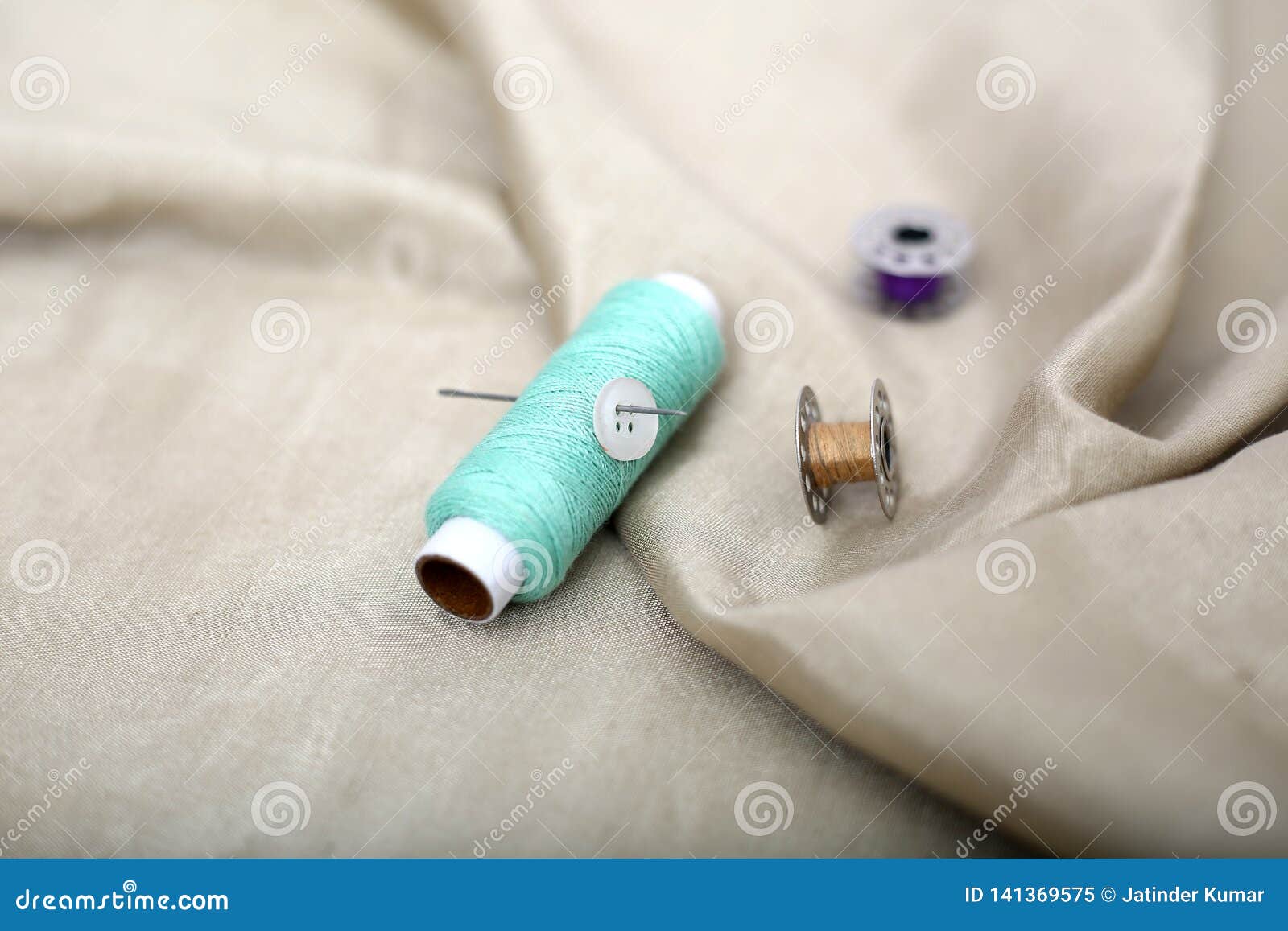 Portrait of Sewing Thread, Button and Two Bobbin on the Cloth Stock ...
