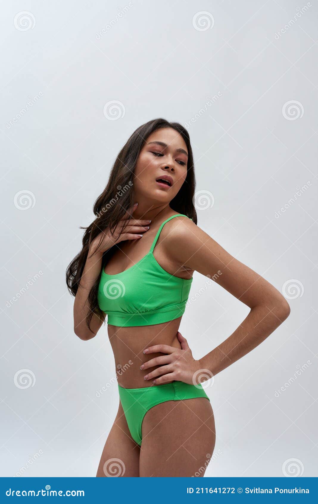 Portrait Of Young Female Model With Slim Body Wearing Green Underwear Looking Aside Posing For