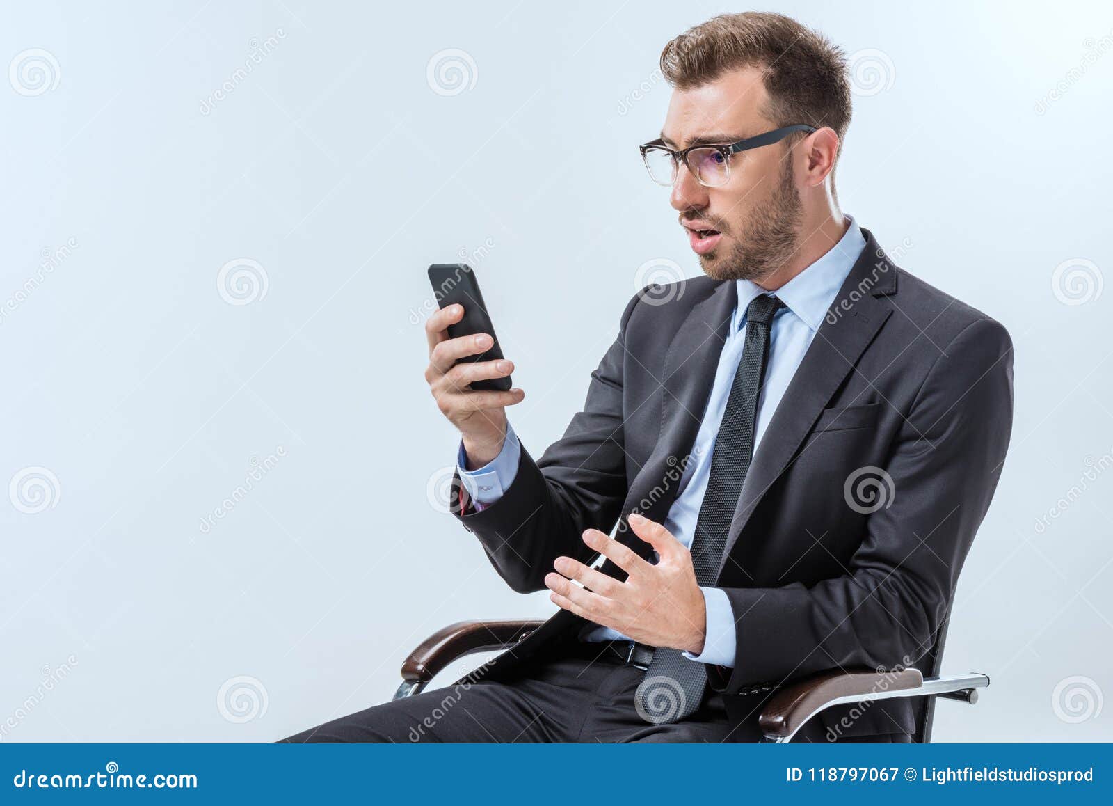 Portrait Of Shocked Businessman Looking At Smartphone In Hands Stock