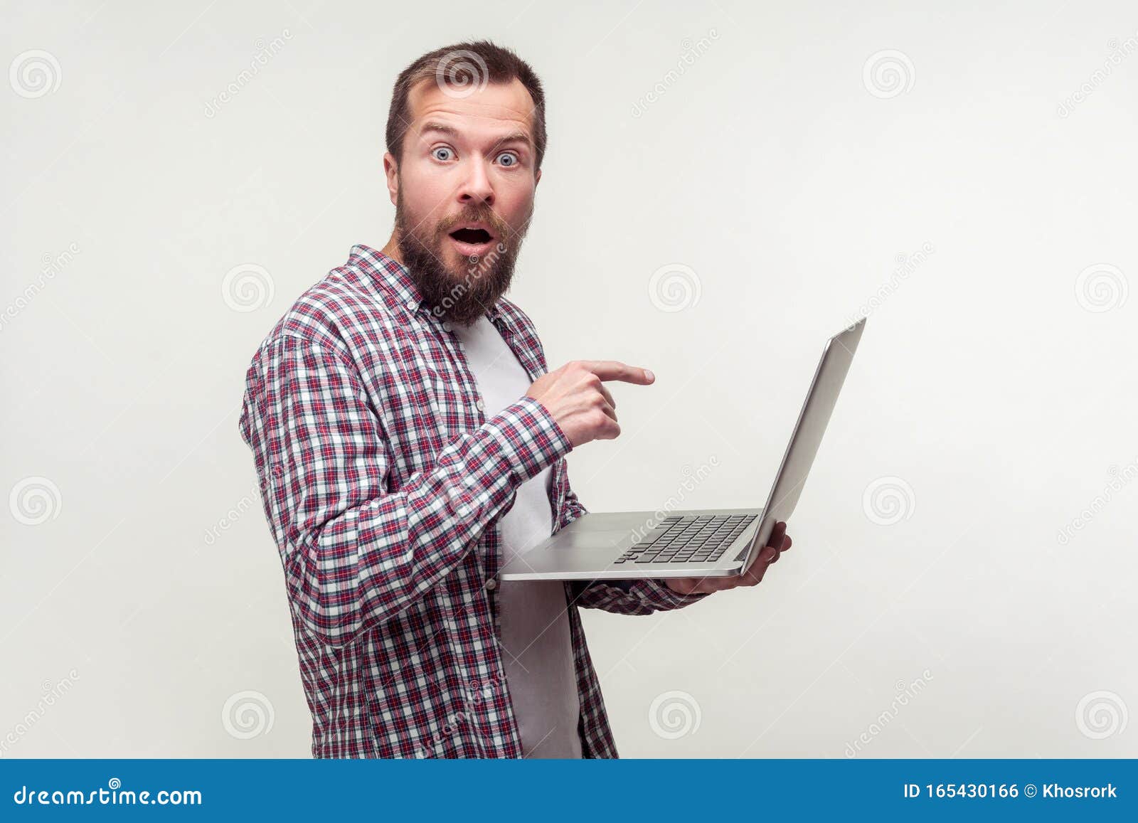 Portrait Of Shocked Computer User Bearded Man Pointing At Laptop