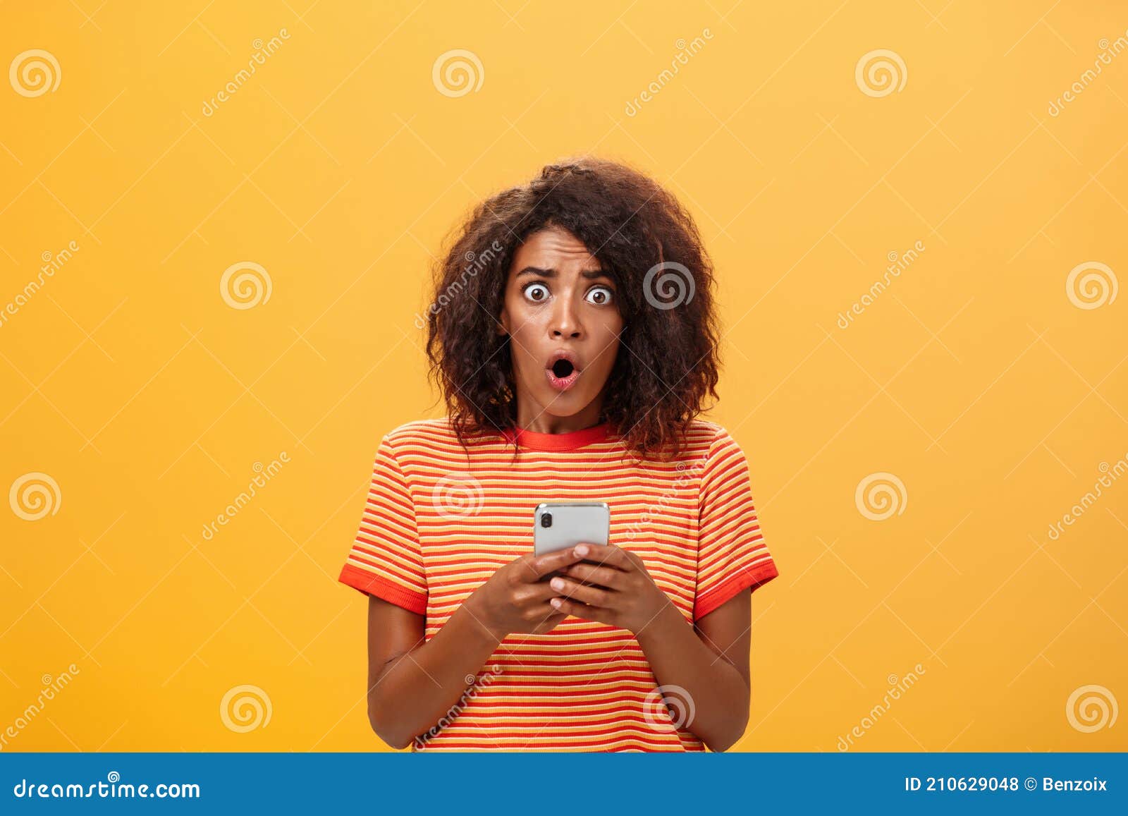 Portrait Of Shocked And Concerned Stunned Dark Skinned Woman With Afro