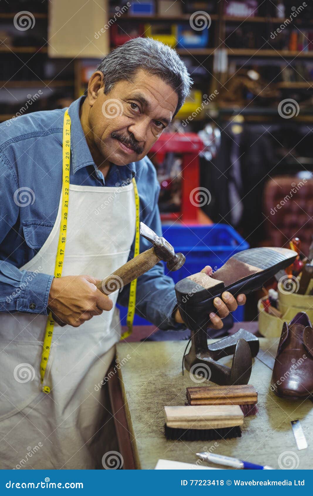 Portrait Of Shoemaker Wearing Black Gloves Inserts Wooden Shoe Pad Into ...