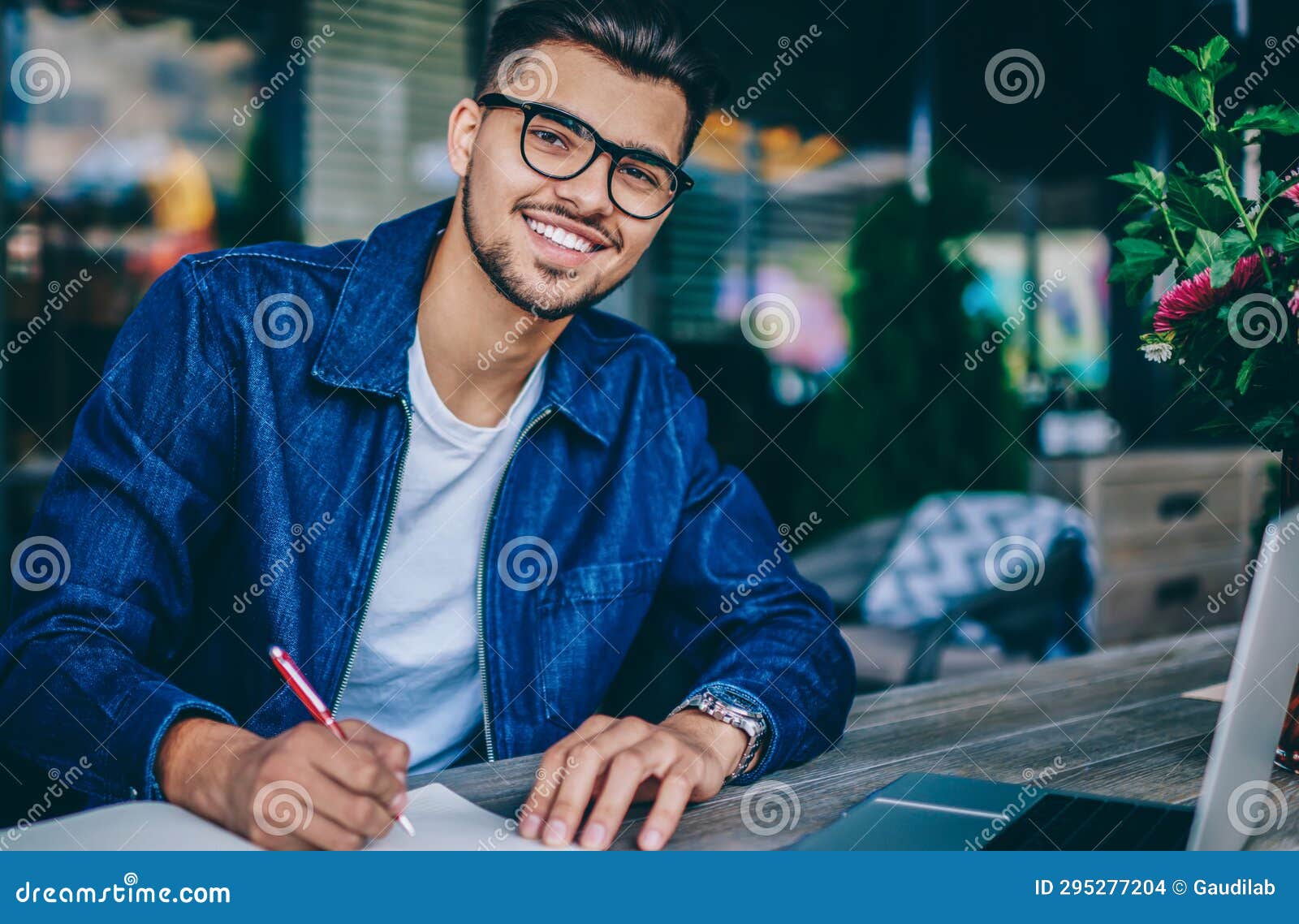 Portrait of Skilled Caucasian Male Student Writing in Notepad Enjoying ...