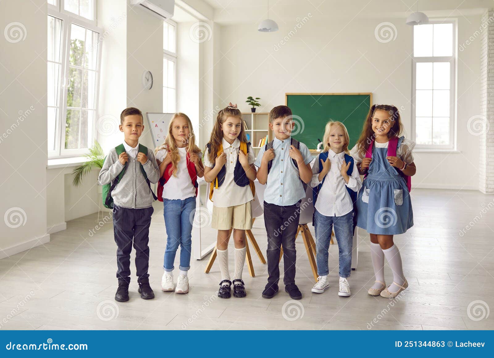 Portrait of Small Smiling Group of First Graders in Modern Elementary ...