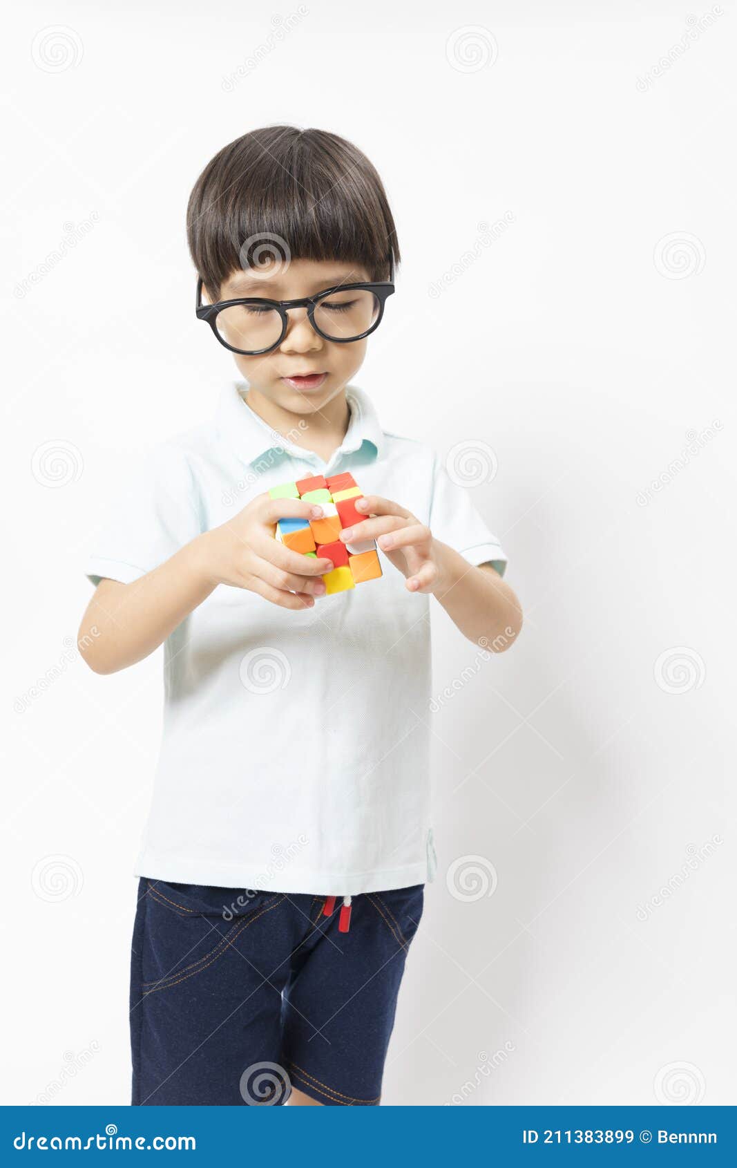 Asian Kid Play Magic Rubik Cube on White Background. Editorial Stock ...
