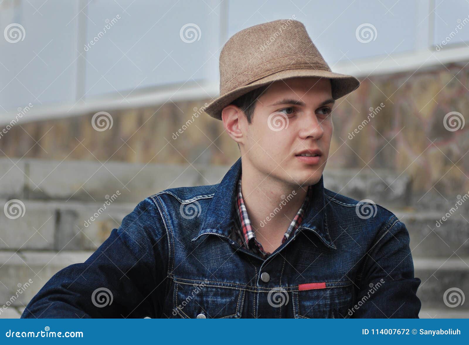 Portrait of Smart Young Man Sitting with Interesting Face Stock Photo ...