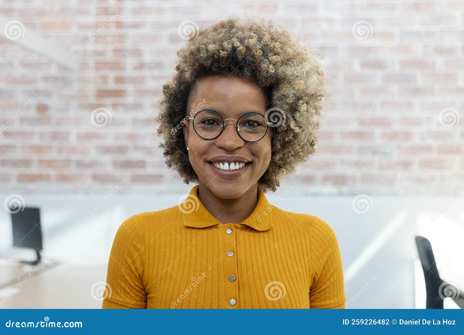 Portrait Of Smiling African American Woman Looking At Camera With