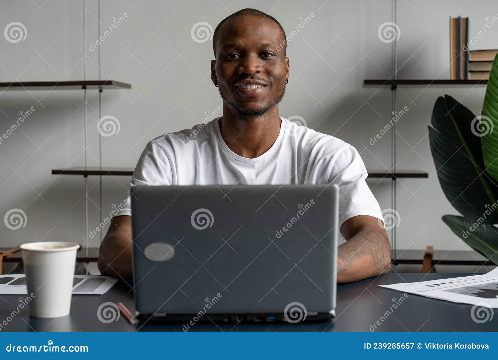 Portrait of a Smiling Black Man Using a Laptop and Looking at the ...