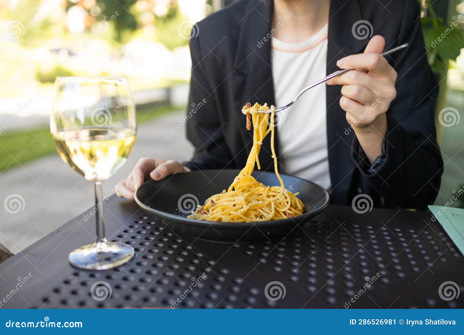 Portrait Of A Smiling Blonde Woman Eating Italian Pasta Carbonara And