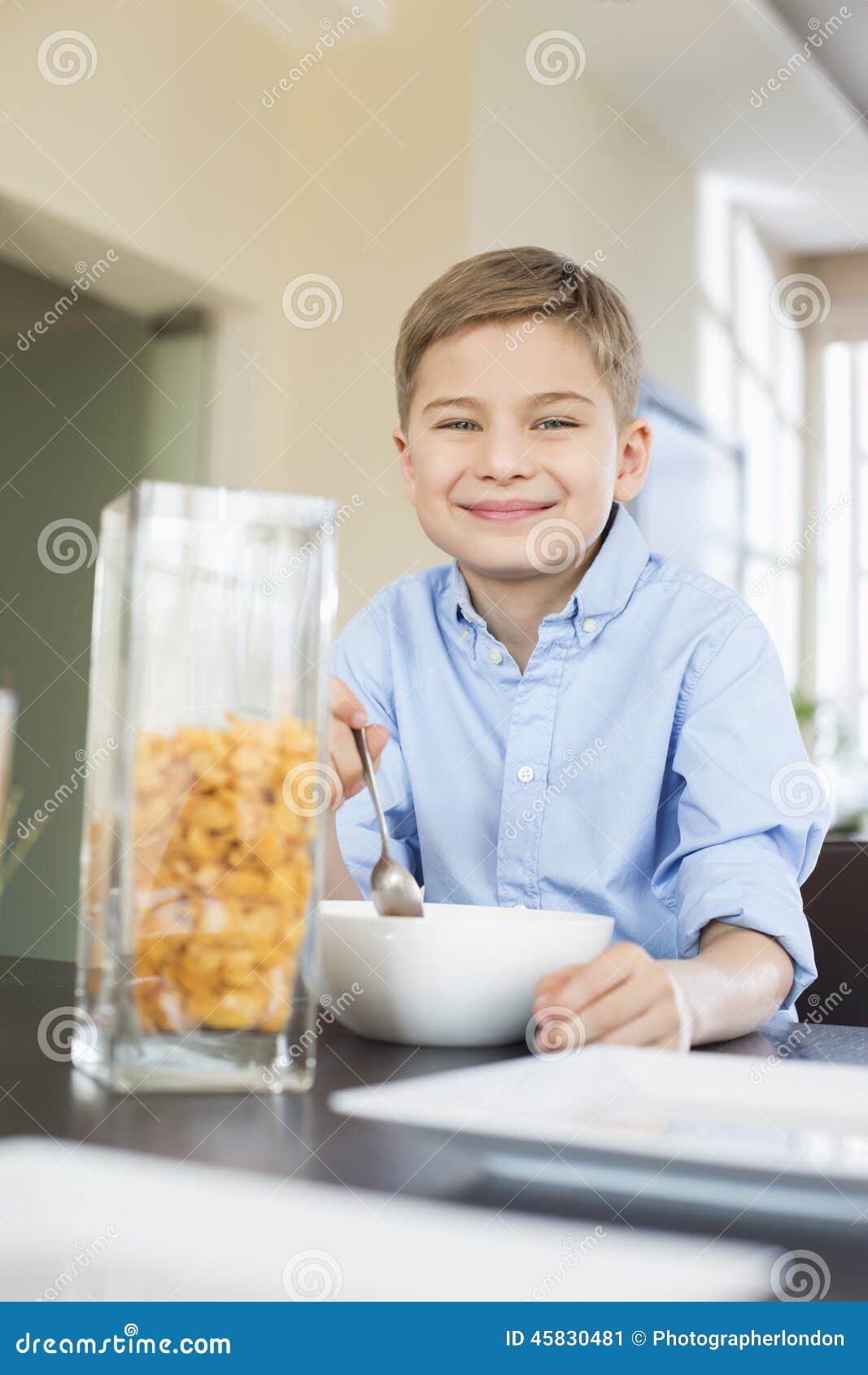 Portrait of Smiling Boy Pouring Corn Flakes in Bowl at Home Stock Image ...
