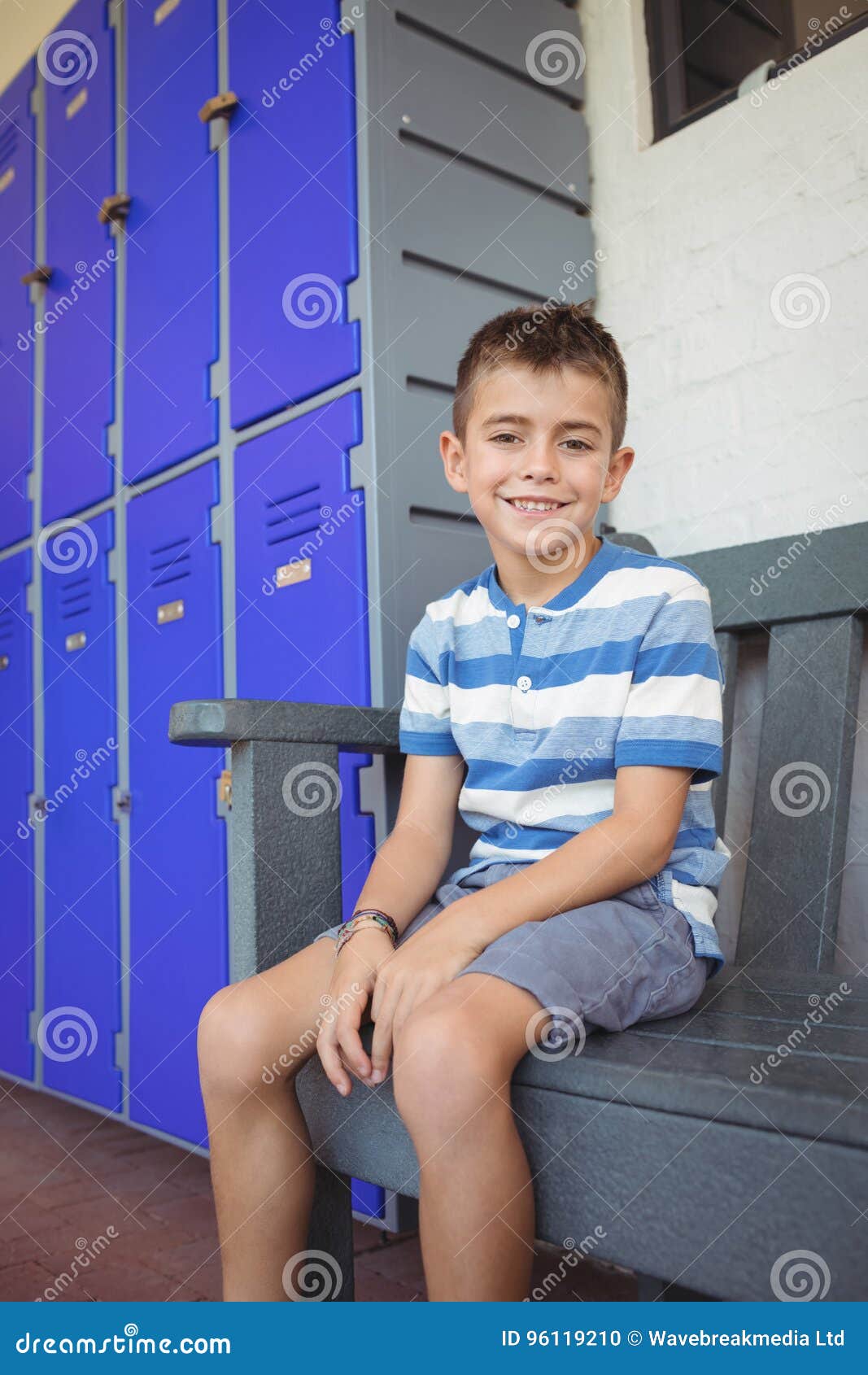 Portrait of Smiling Boy Sitting on Bench by Lockers Stock Photo - Image ...