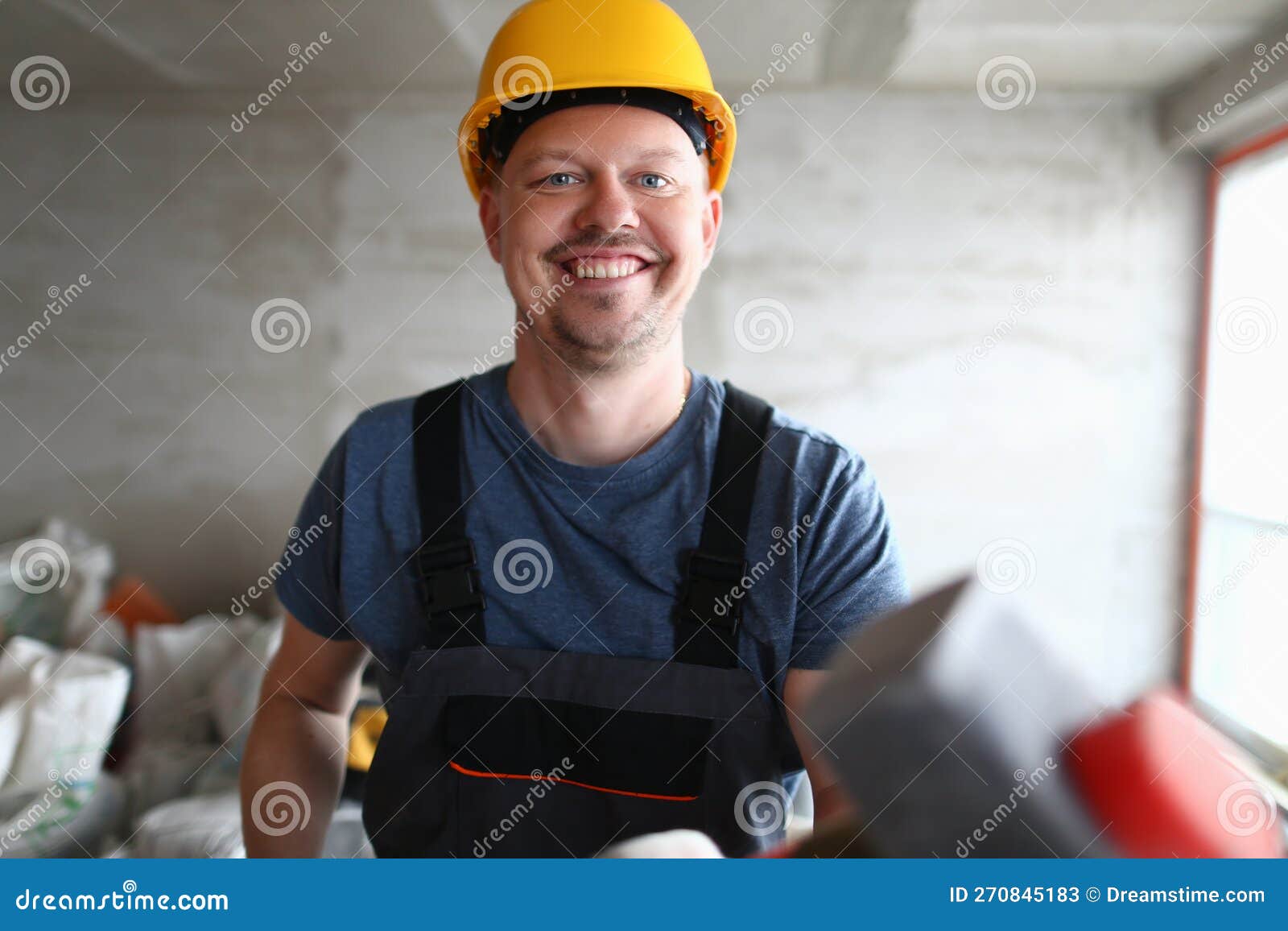 Portrait of Smiling Builder at Construction Site with Sledgehammer in ...