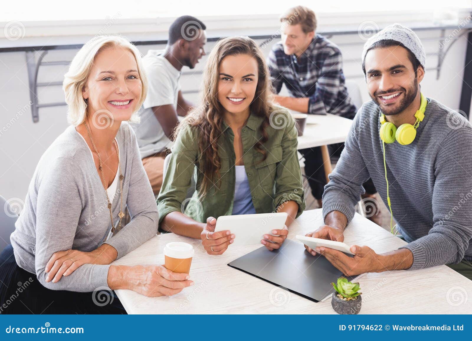 Portrait of Smiling Business People Sitting at Table Stock Photo ...