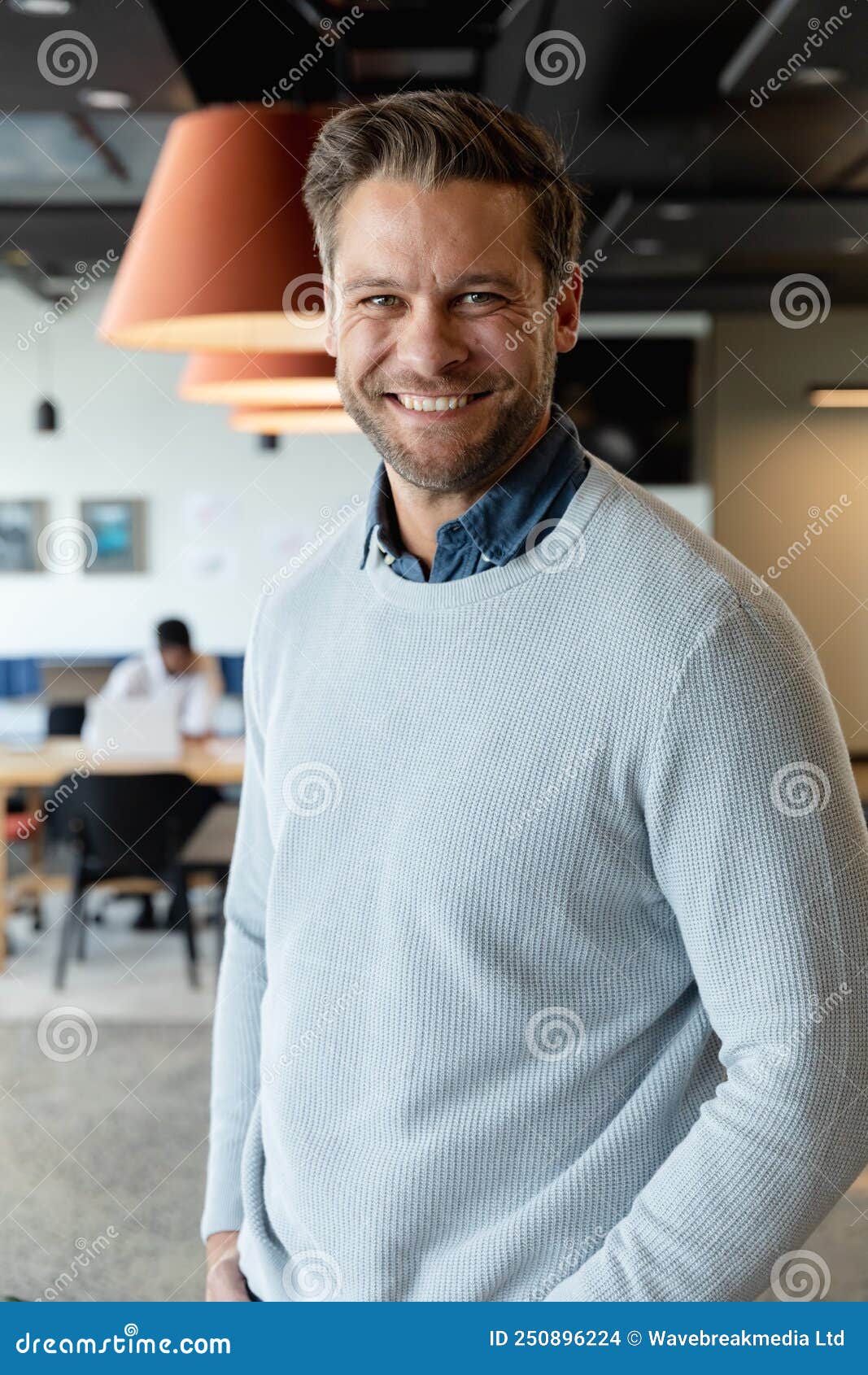 Portrait Of Smiling Caucasian Mid Adult Businessman At Creative Office