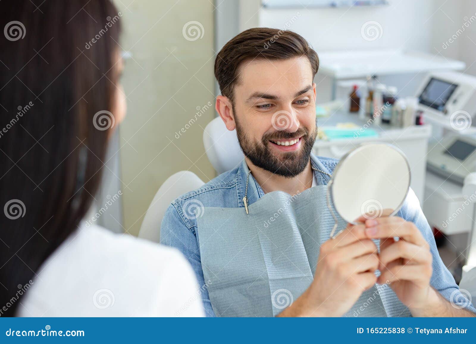 Portrait of Smiling Client Looking at Teeth in the Mirror Stock Photo ...