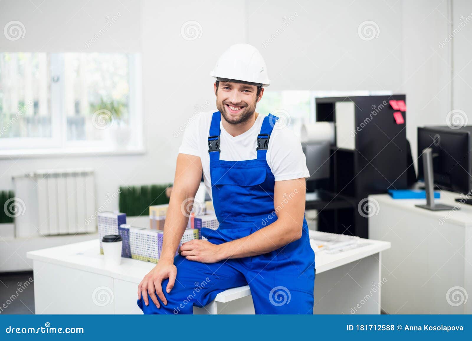 A Portrait of a Smiling Construction Site Supervisor in the Office ...